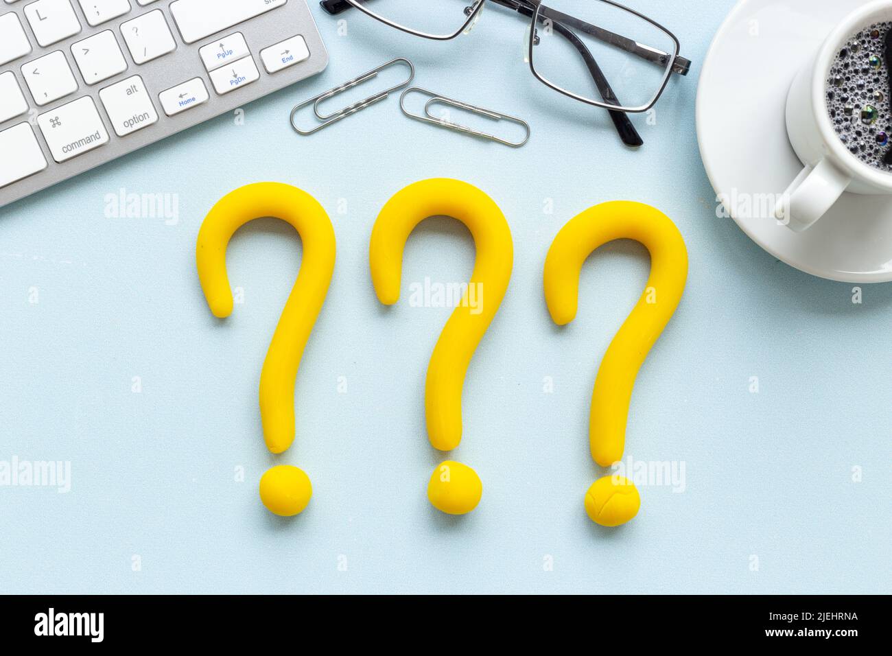 Question mark signs on office table. Customer support servise or FAQ ...