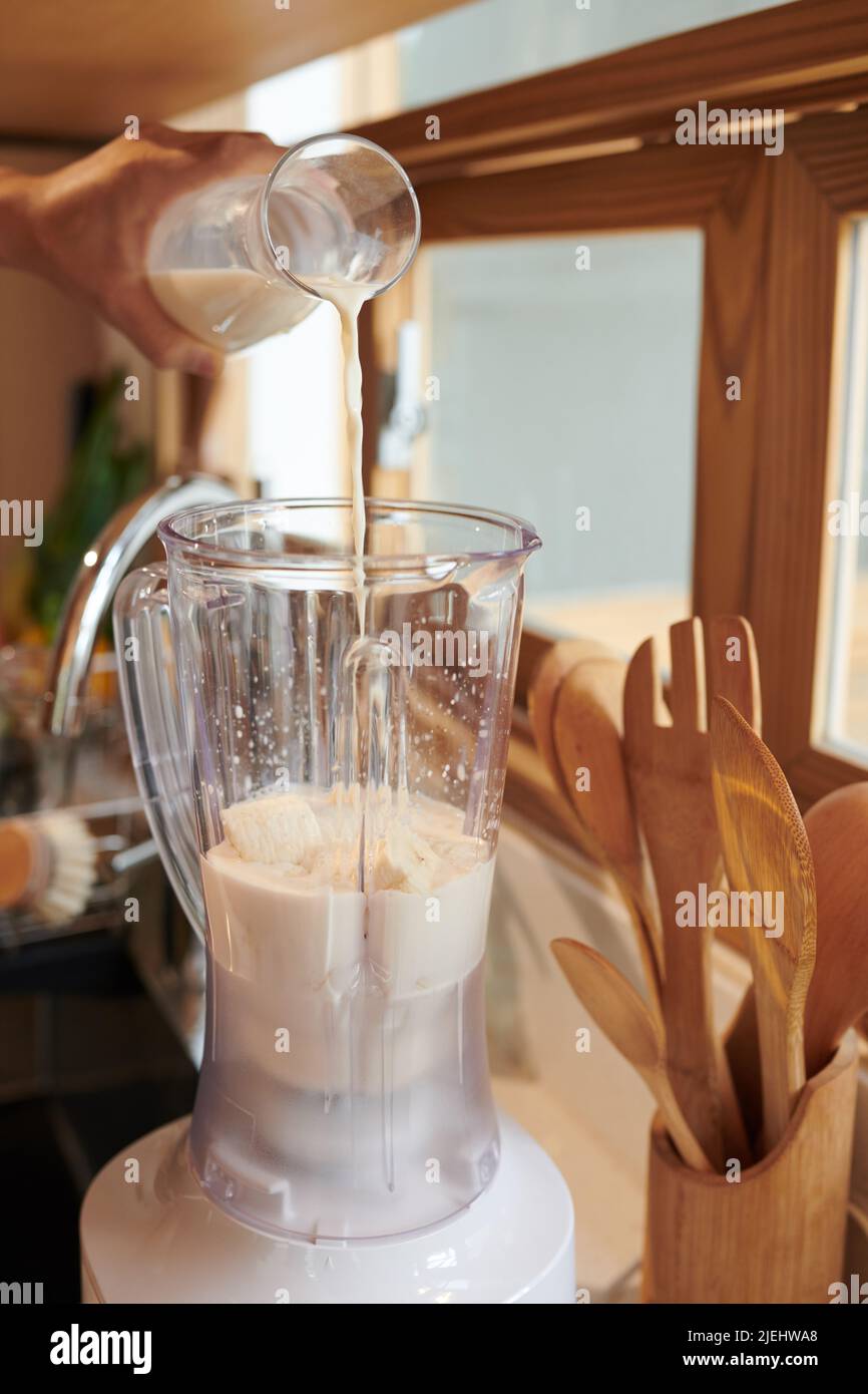Man pouring non-diary milk in blender with when making smoothie Stock ...