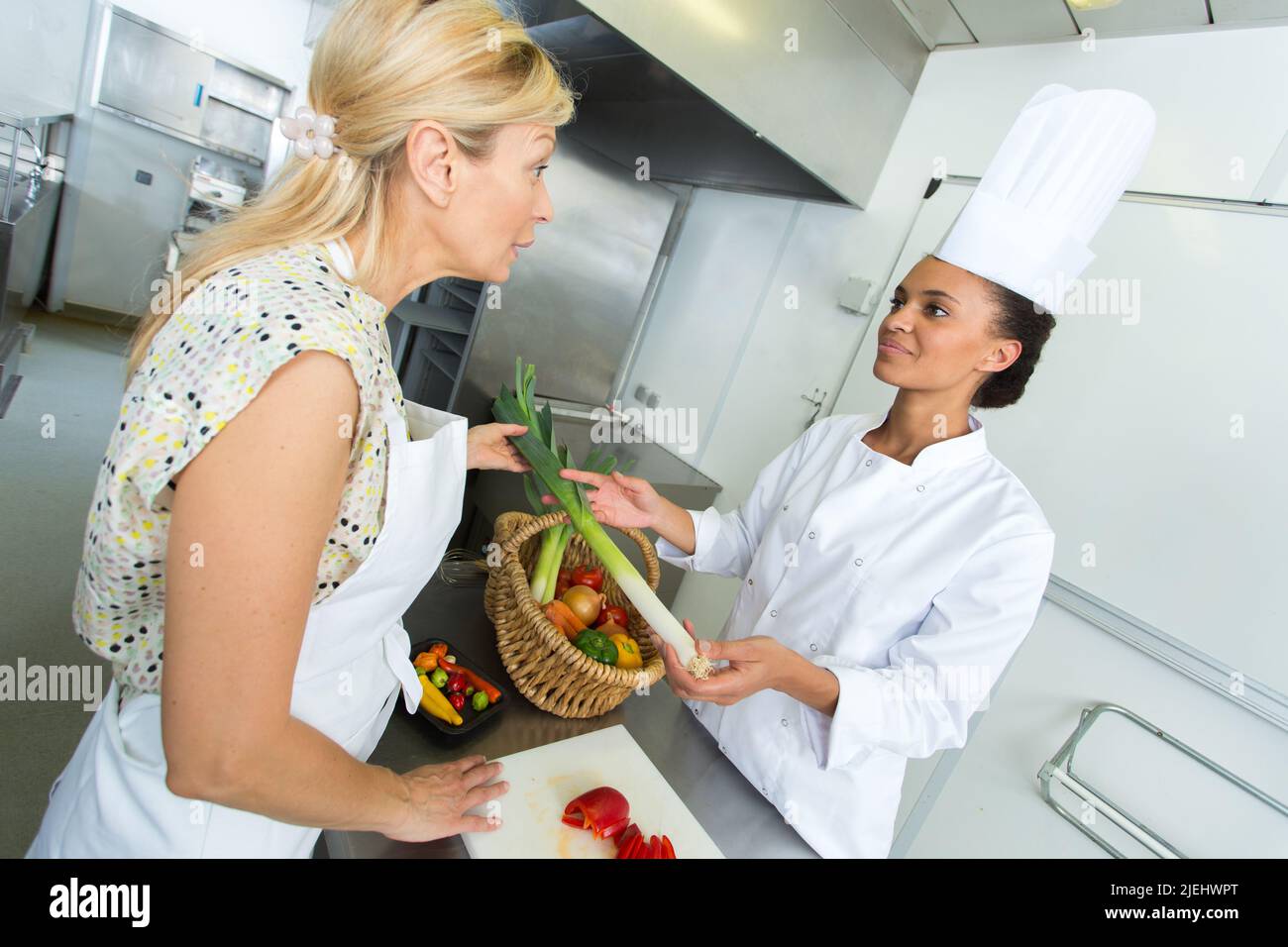 two female chefs in gastronomic kitchen Stock Photo - Alamy