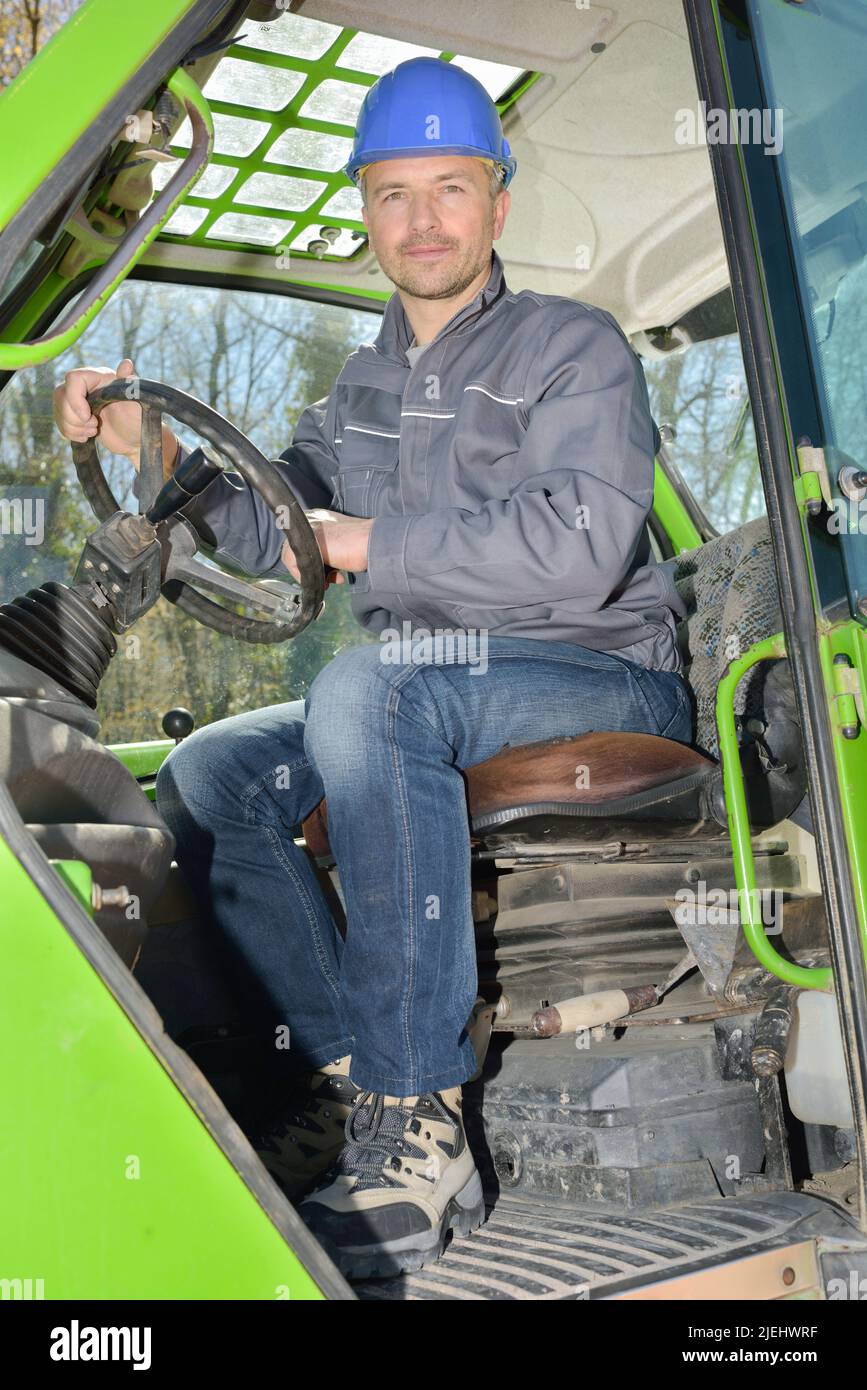 builer with helmet drives a vehicule Stock Photo - Alamy