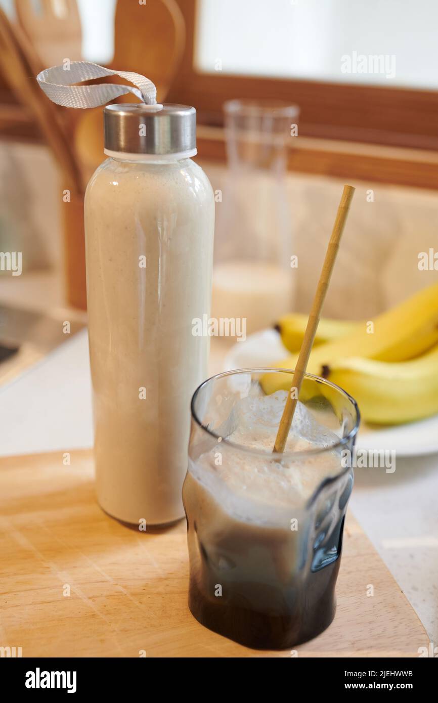 Bottle and glass with protein milkshake on kitchen counter Stock Photo ...
