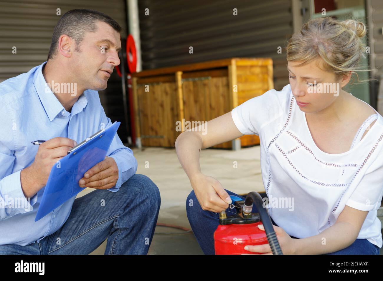 grading a firefighting female student Stock Photo - Alamy