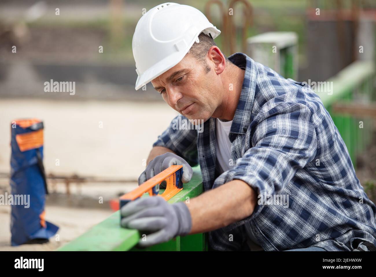 construction worker using spirit level in a new house Stock Photo - Alamy