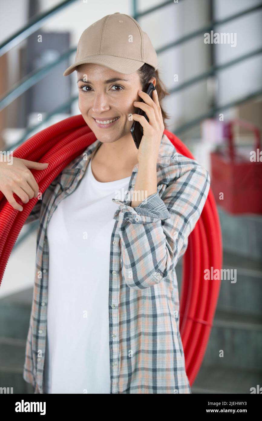 female plumber on the phone and equipment Stock Photo - Alamy