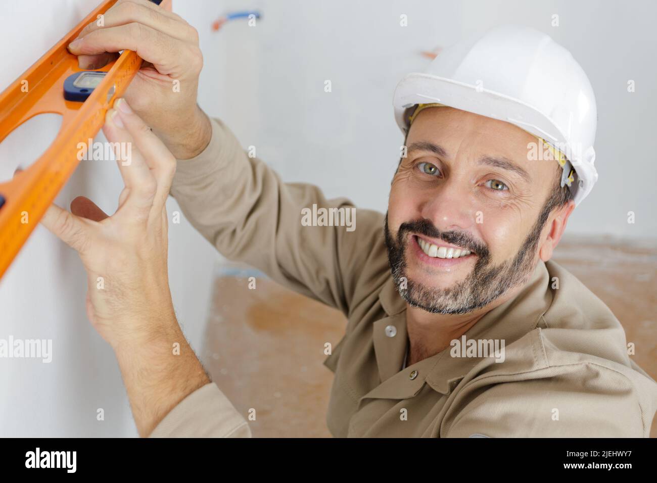a tradesman using spirit level Stock Photo - Alamy