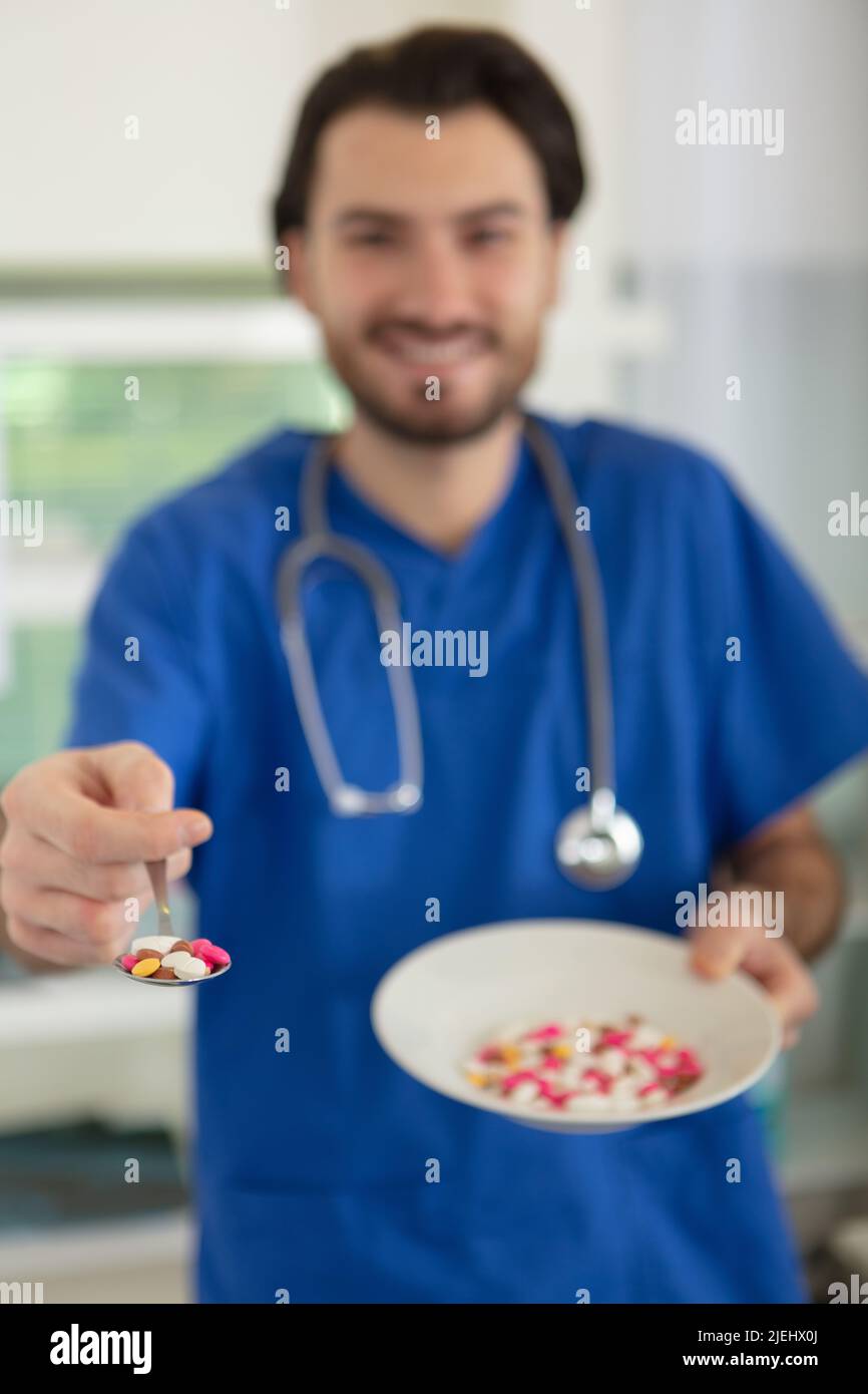 attractive doc holding plates of pills Stock Photo - Alamy