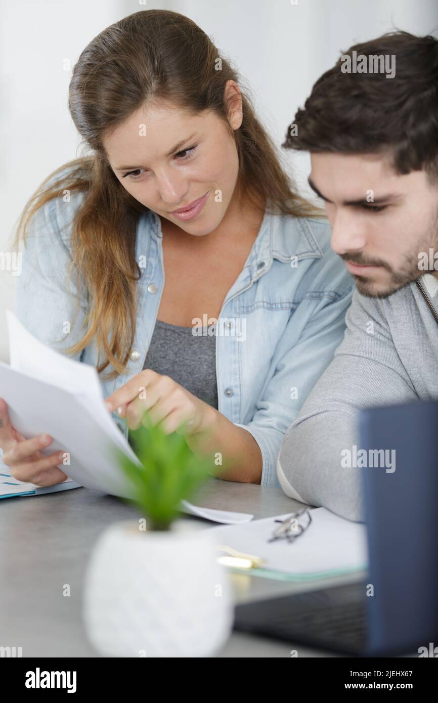 a young couple checking paperwork Stock Photo - Alamy