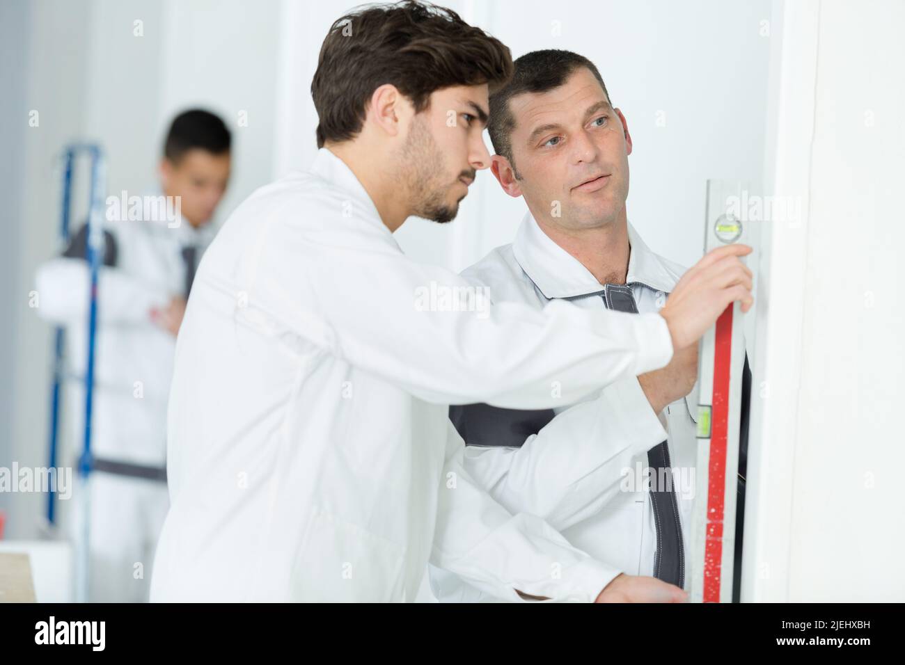 builders is measuring wall with level Stock Photo - Alamy