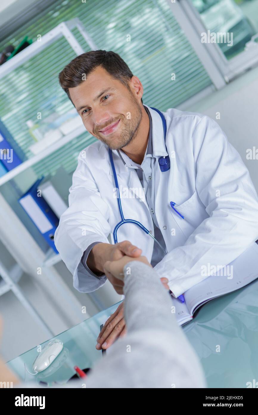 Female doctor patient handshaking hi-res stock photography and images ...