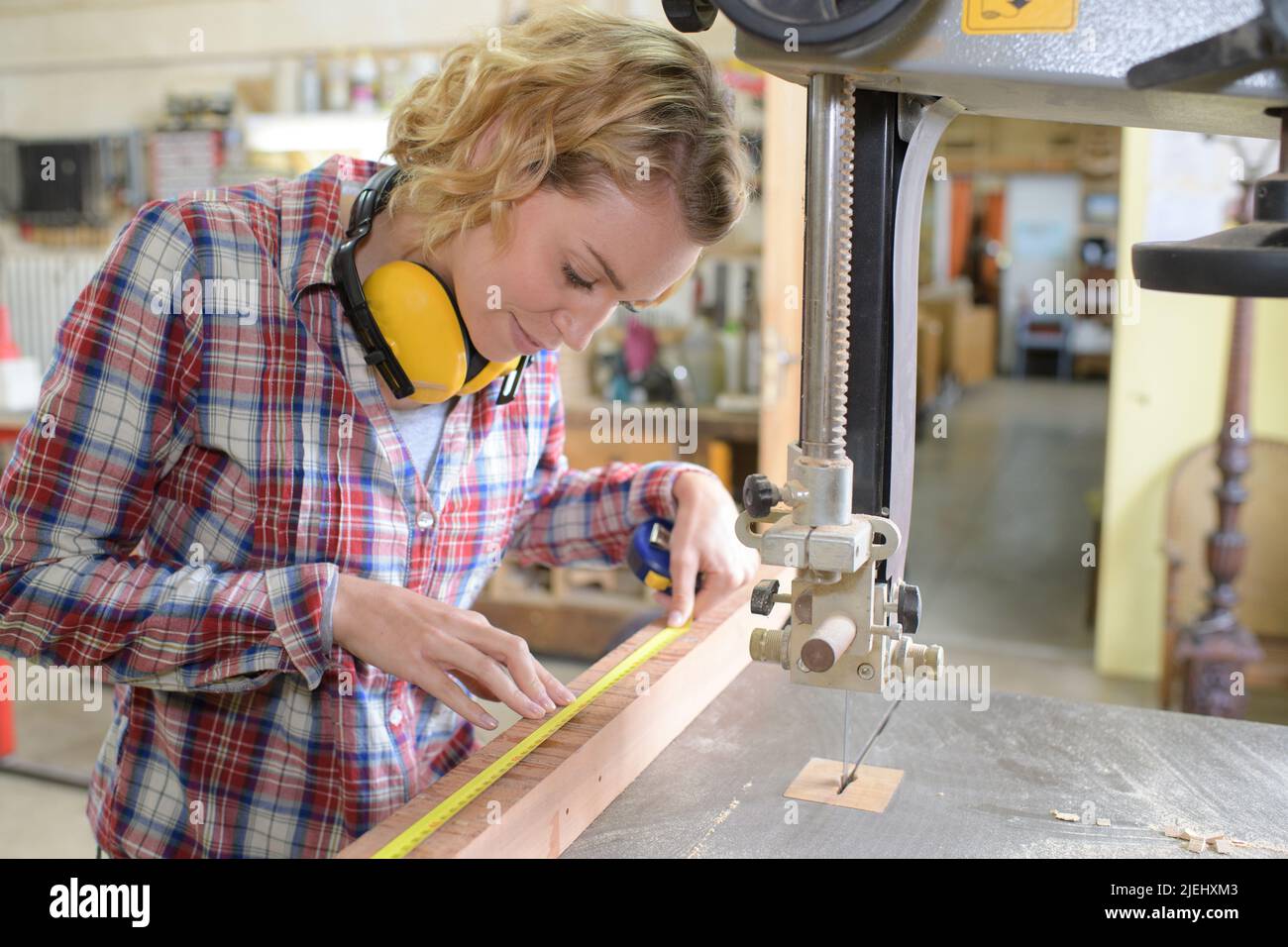 a female carpenter measuring wood Stock Photo - Alamy