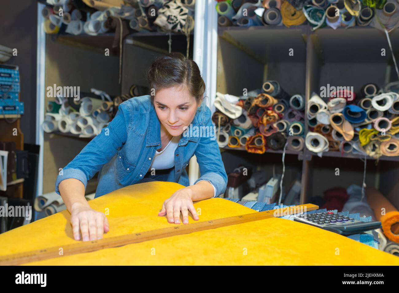 concentrated work of tailor over details of the dress Stock Photo - Alamy