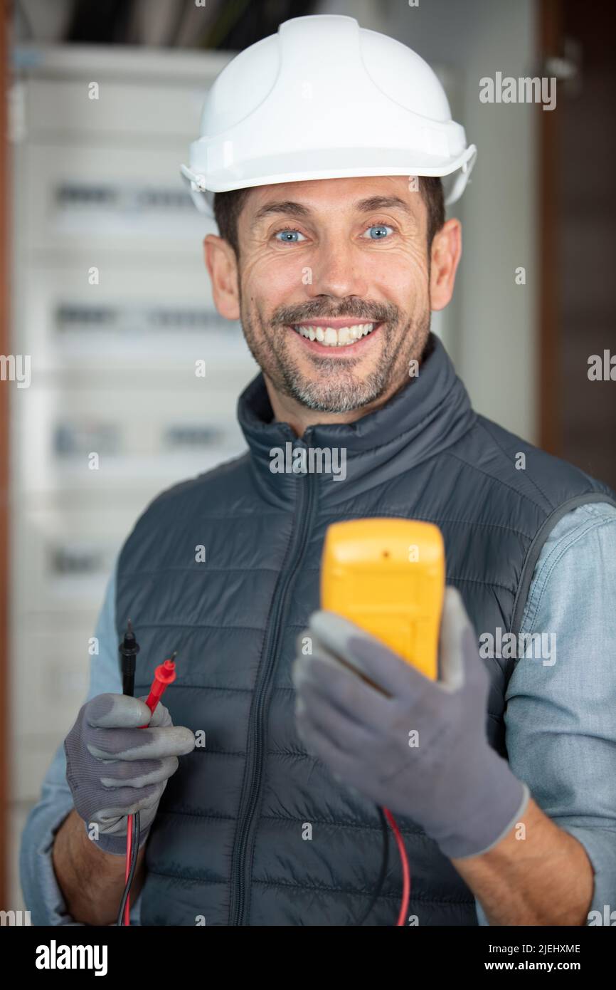 portrait of a young electrician using a multimeter Stock Photo - Alamy