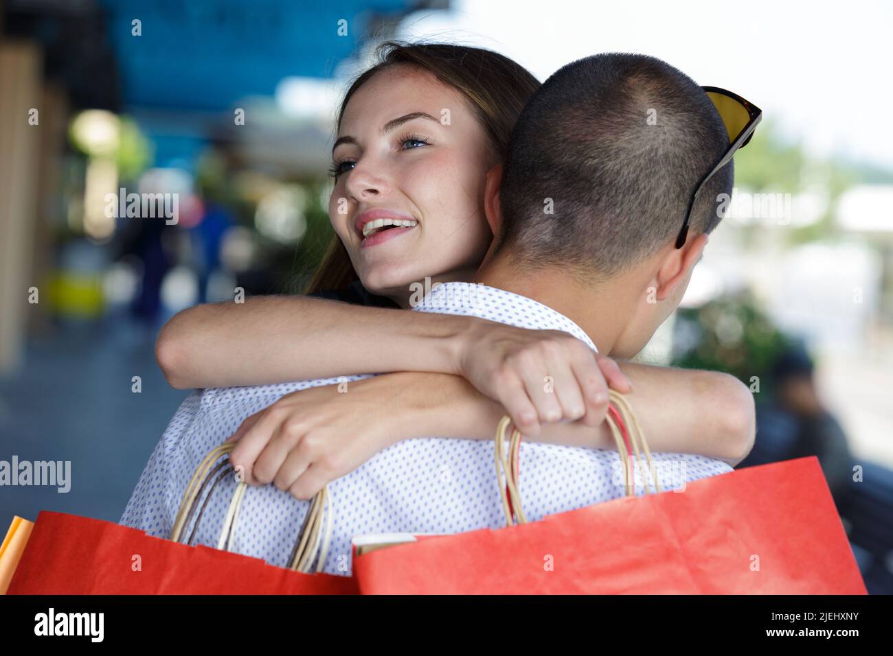 couple hugging in shopping mall Stock Photo - Alamy