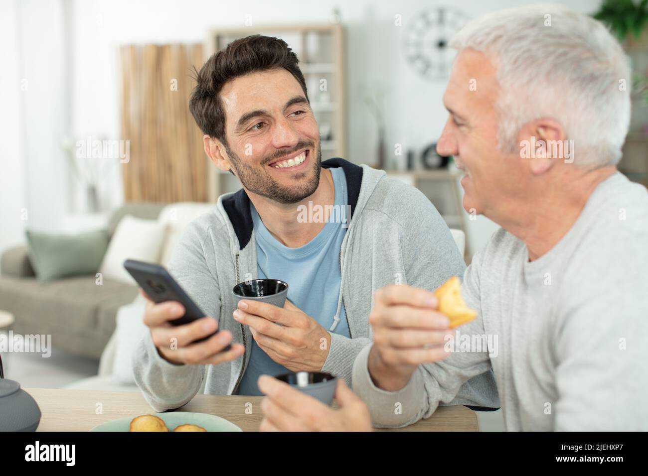 overjoyed aged father embraces grown up child men feels happy Stock ...