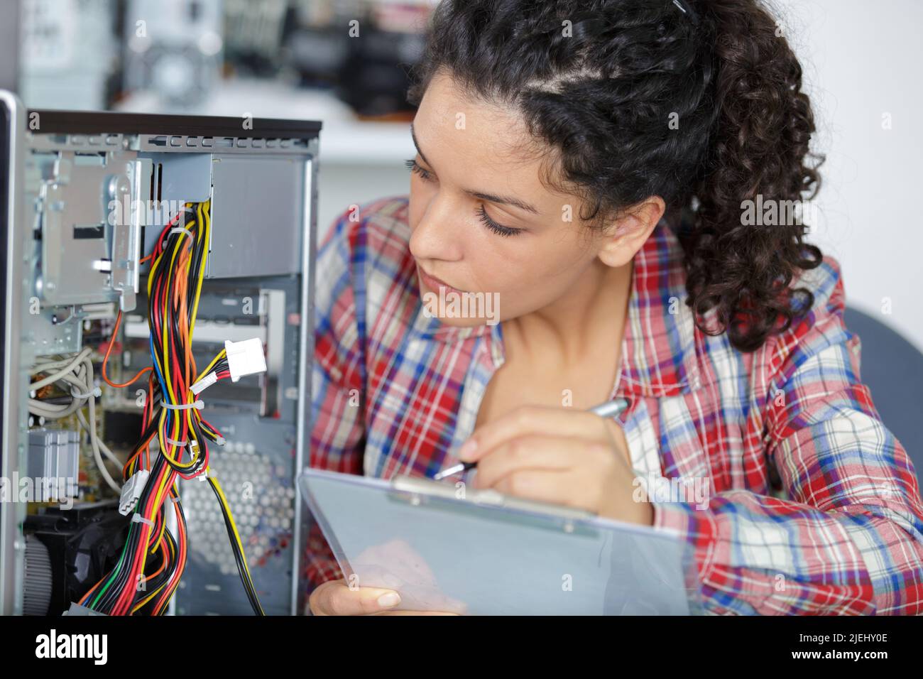 female worker checking pc technical problems Stock Photo - Alamy