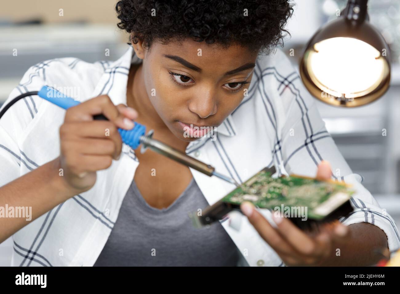 woman is soldering a pc part Stock Photo - Alamy