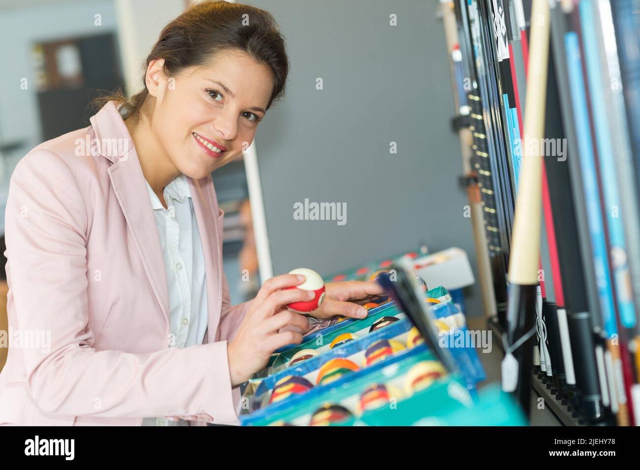 attractive female billiard player choosing balls Stock Photo - Alamy