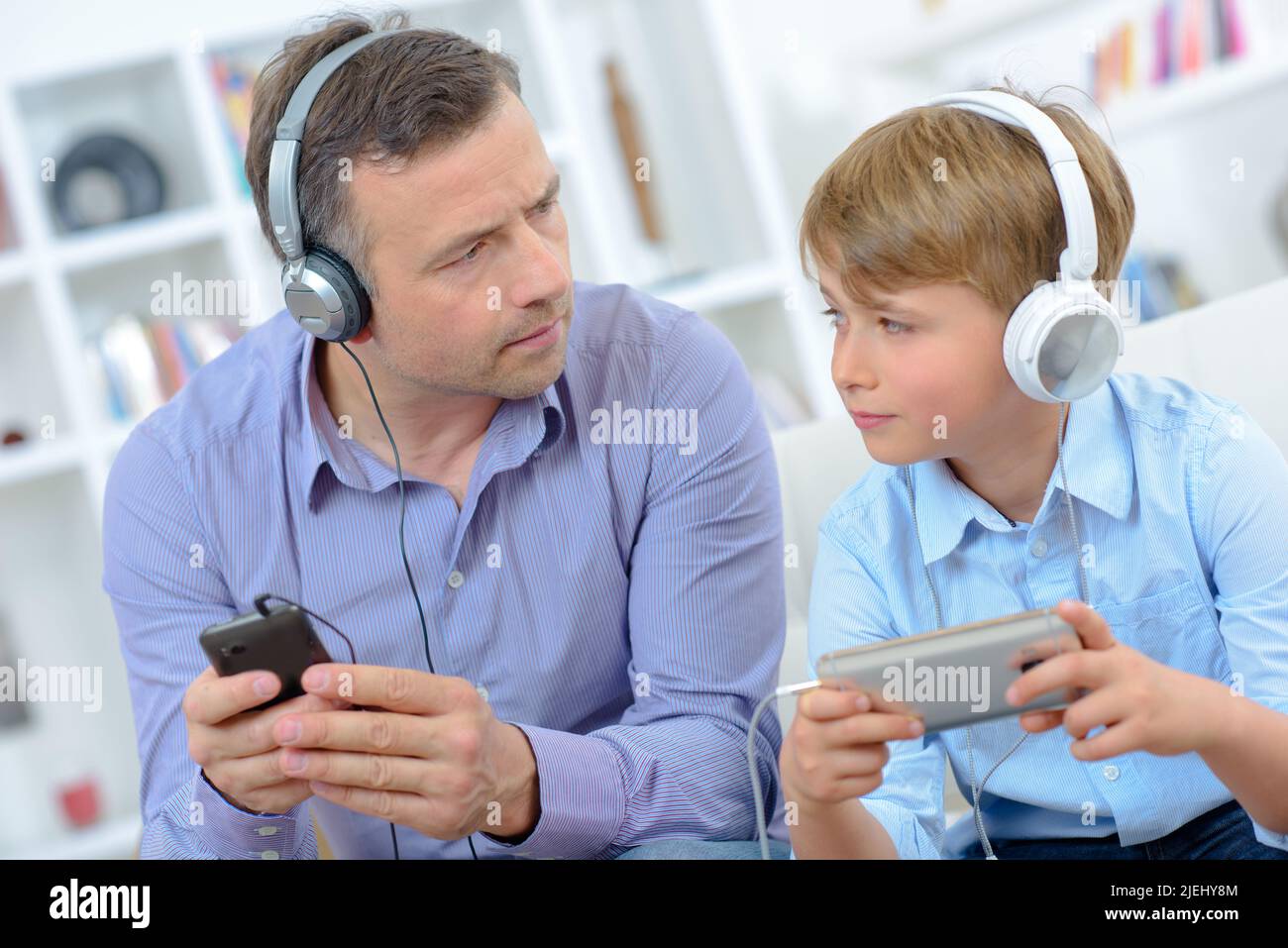 little boy is using his dads phone Stock Photo - Alamy