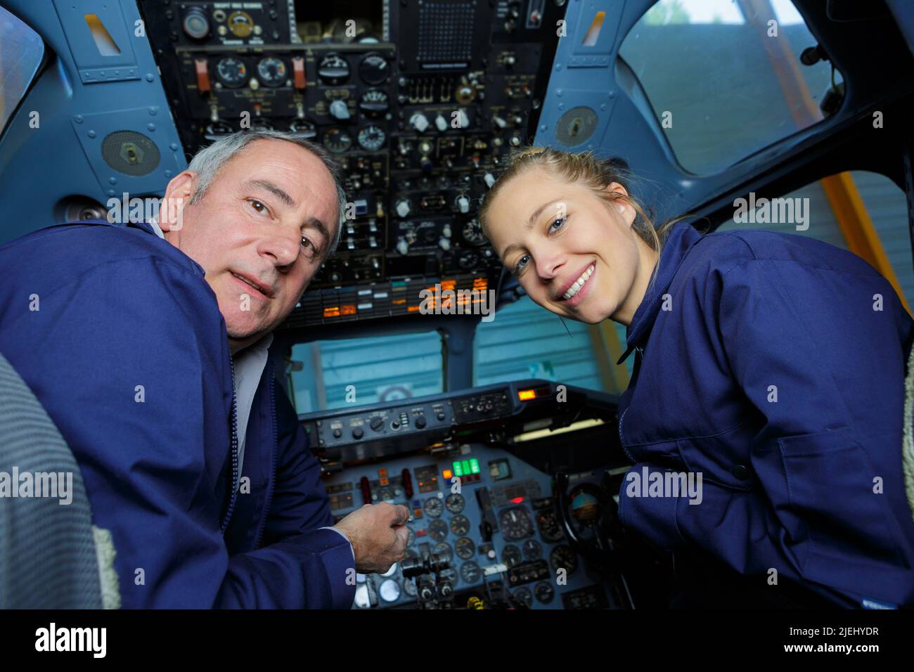 senior man and young woman wearing overalls in aircraft cockpit Stock ...