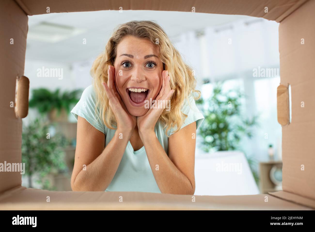 Girl opening cardboard box hi-res stock photography and images - Alamy