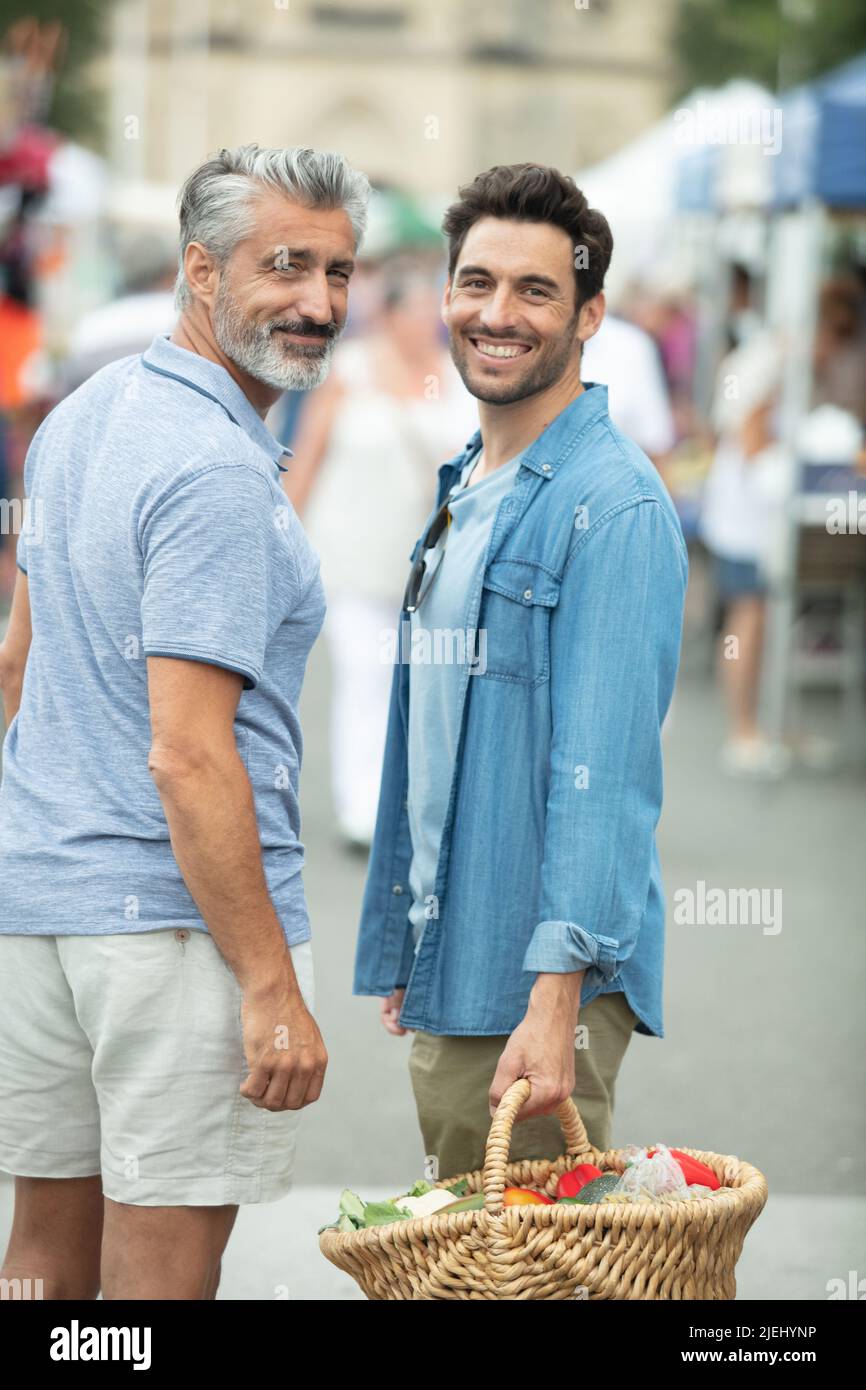 two friends men on street market happy smiling Stock Photo - Alamy