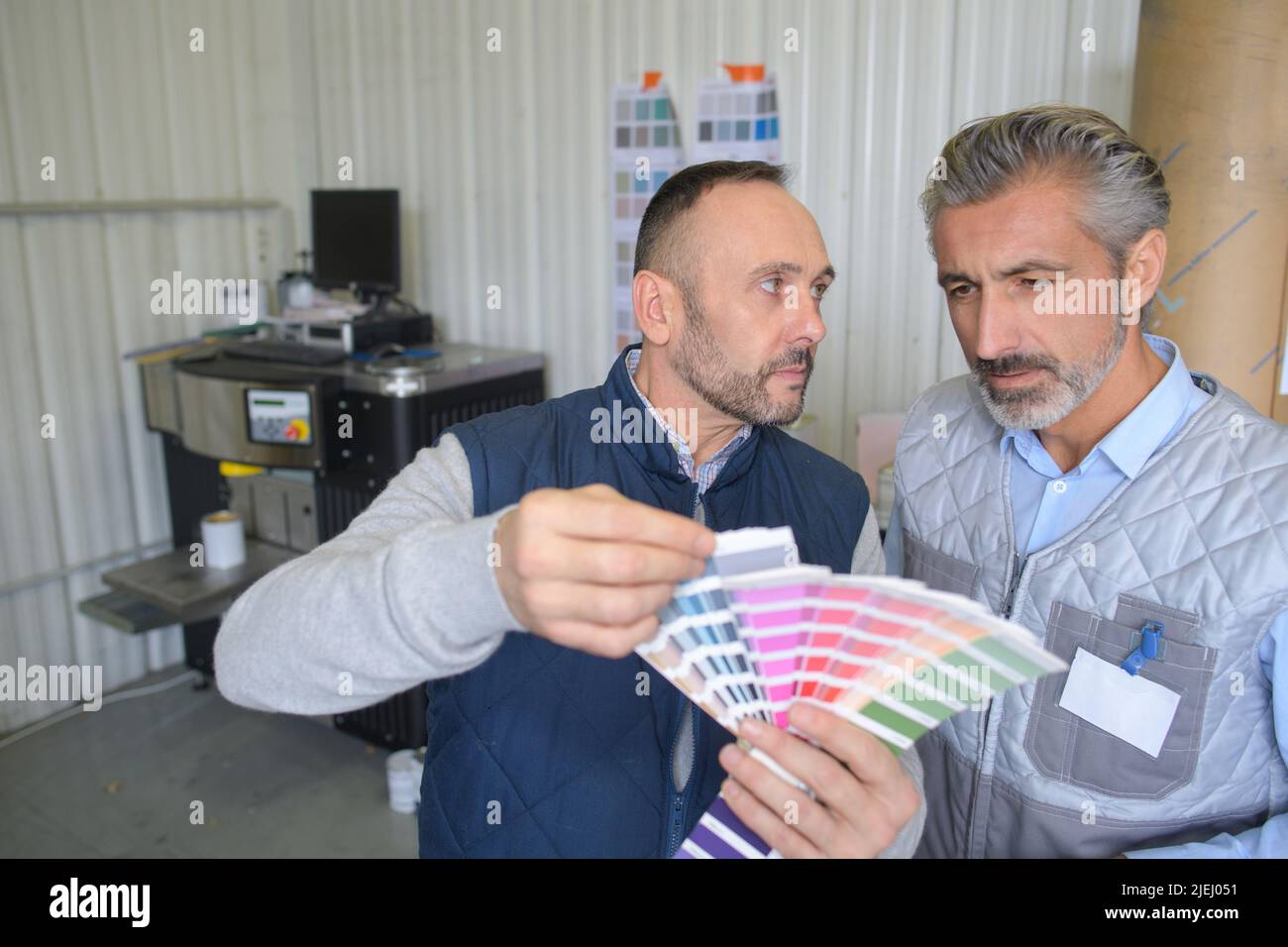 workers holding a color palette Stock Photo - Alamy
