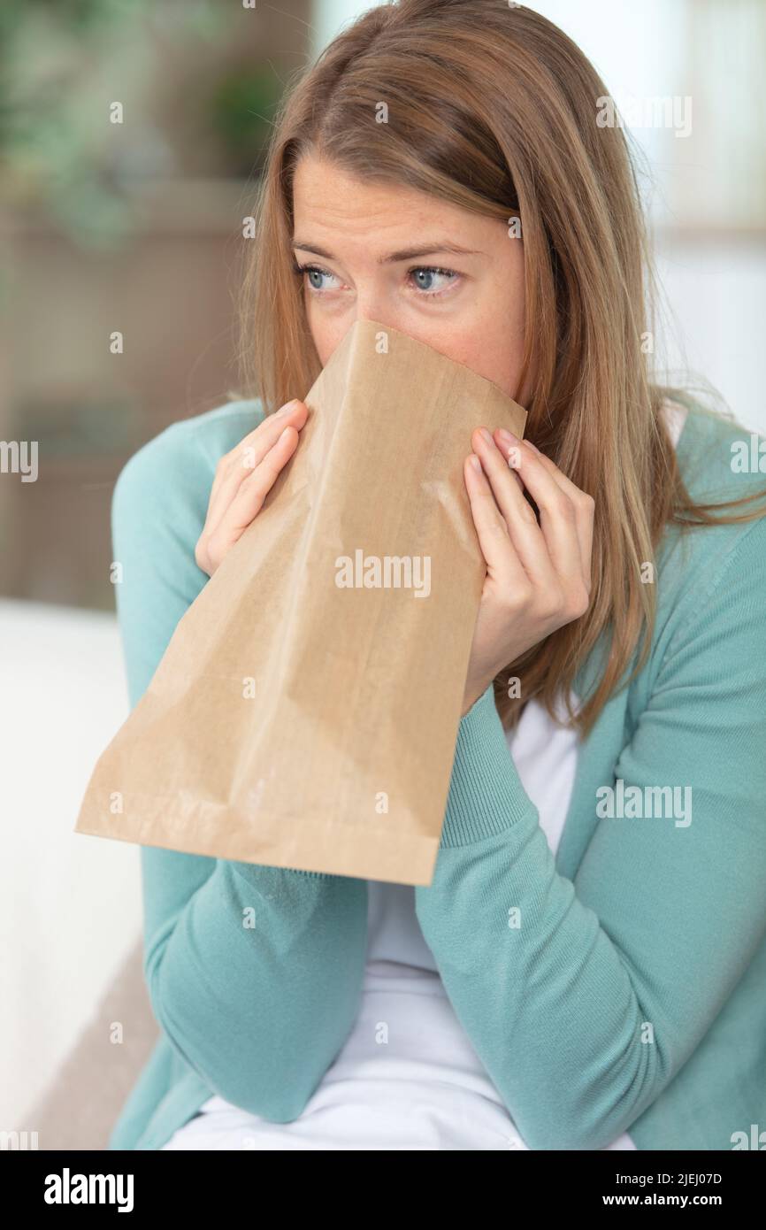 breathless-woman-at-home-breathing-into-a-paper-bag-stock-photo-alamy