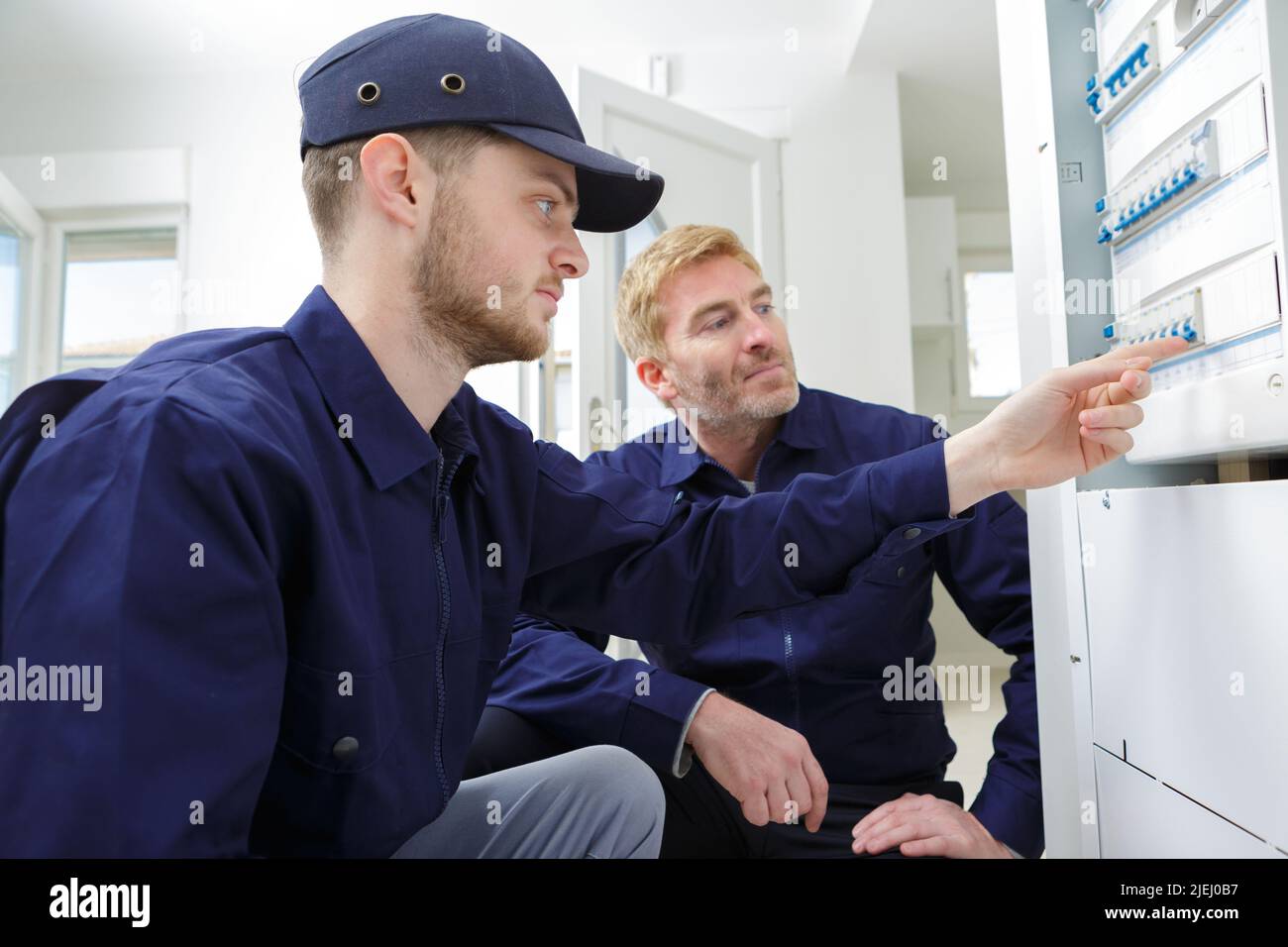 workers on electrical switch box Stock Photo - Alamy
