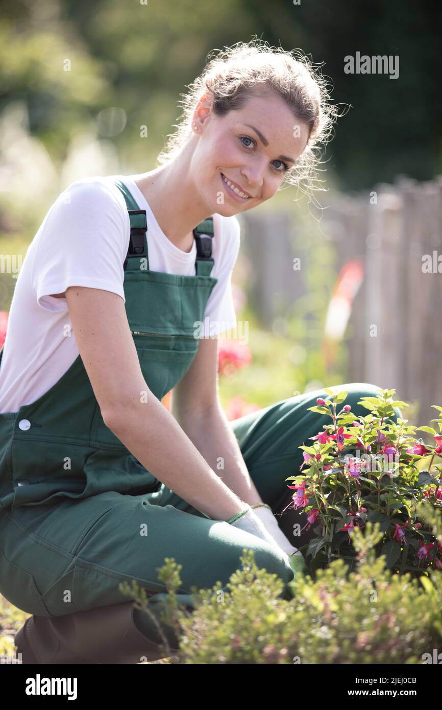 female gardener planting young plants in garden Stock Photo - Alamy