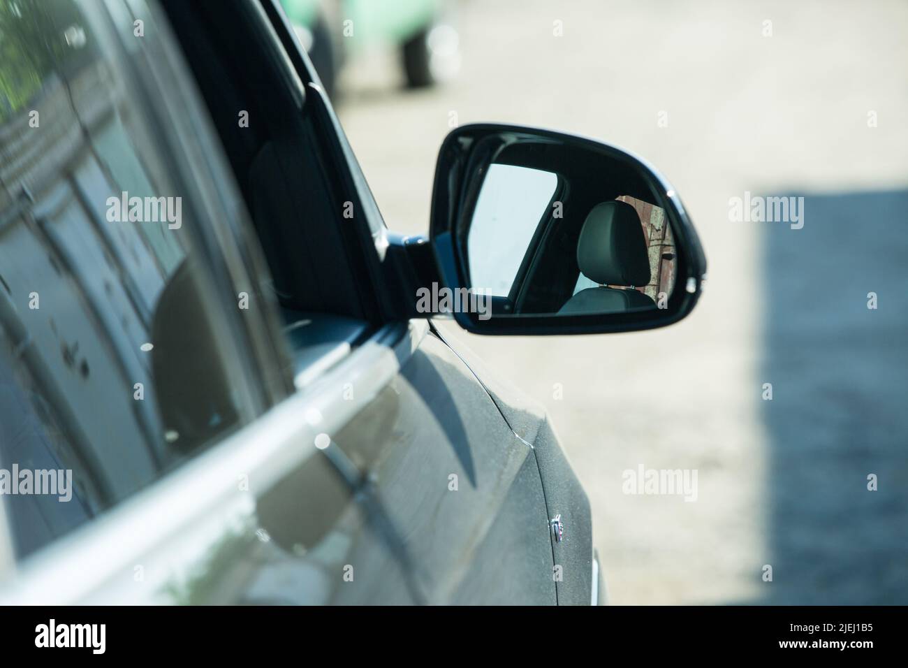 AUDI Q3 in black. Subcompact luxury crossover Audi Q3. Side mirror view ...