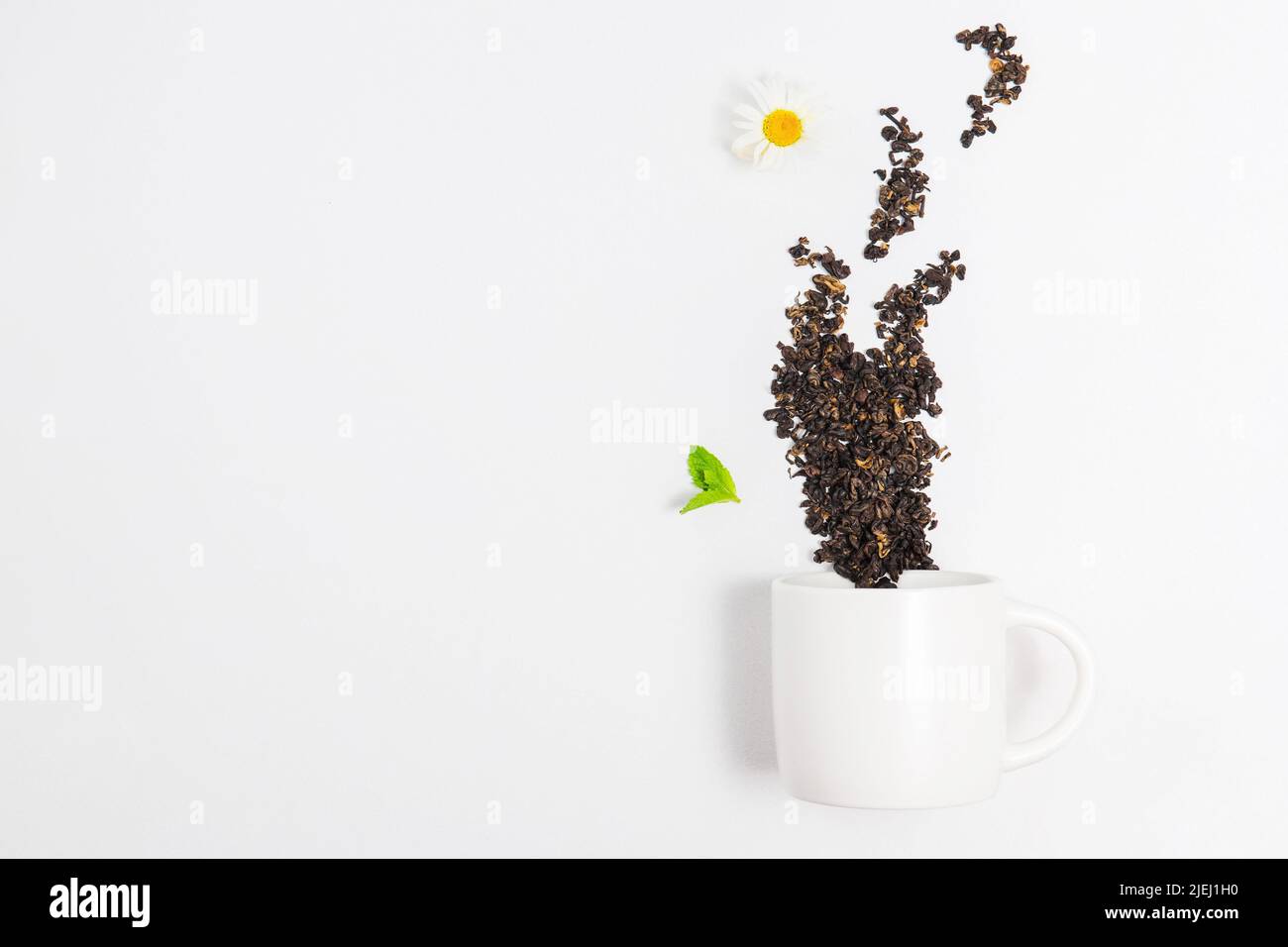 Teacup and scattered red tea leaves in steam shape. Mockup with premium ...