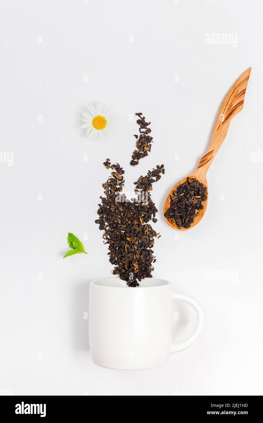 Teacup and scattered red tea leaves in steam shape. Creative mockup ...