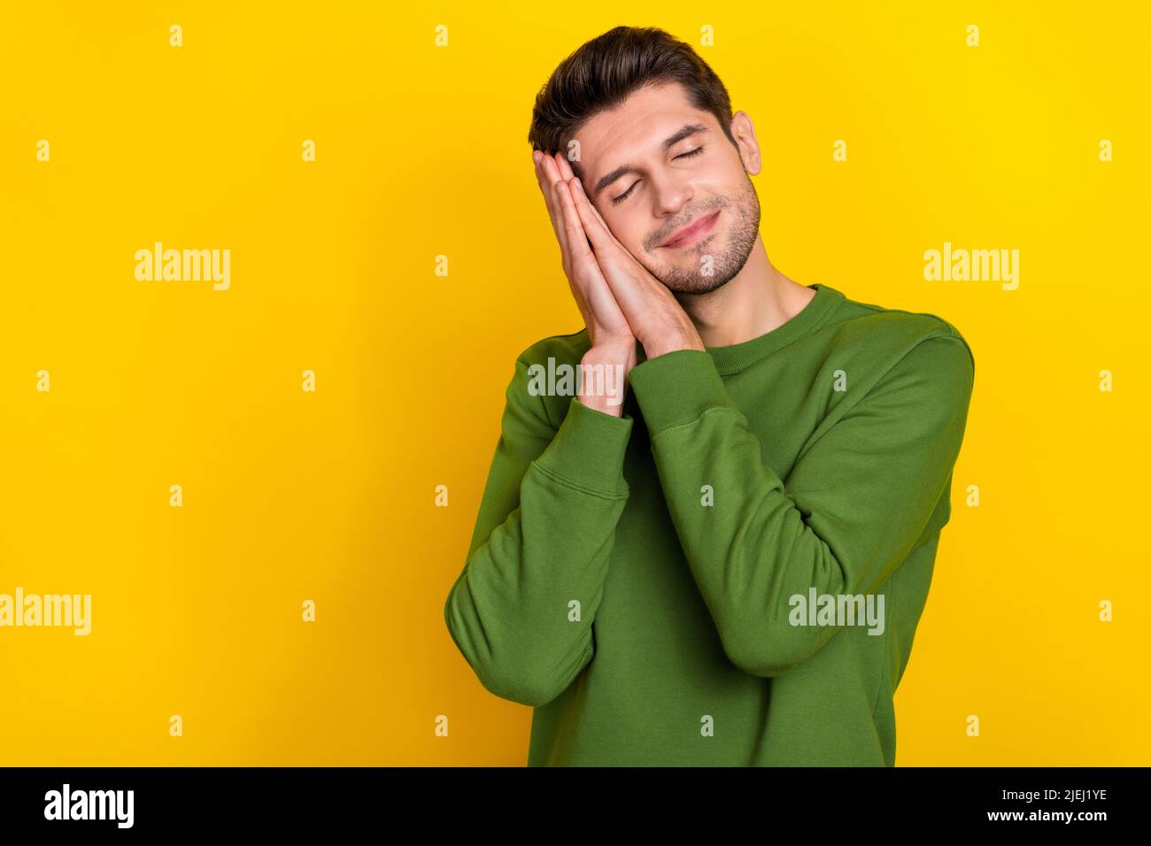 Photo of dreamy tired guy wear green sweater arms cheek sleeping empty ...