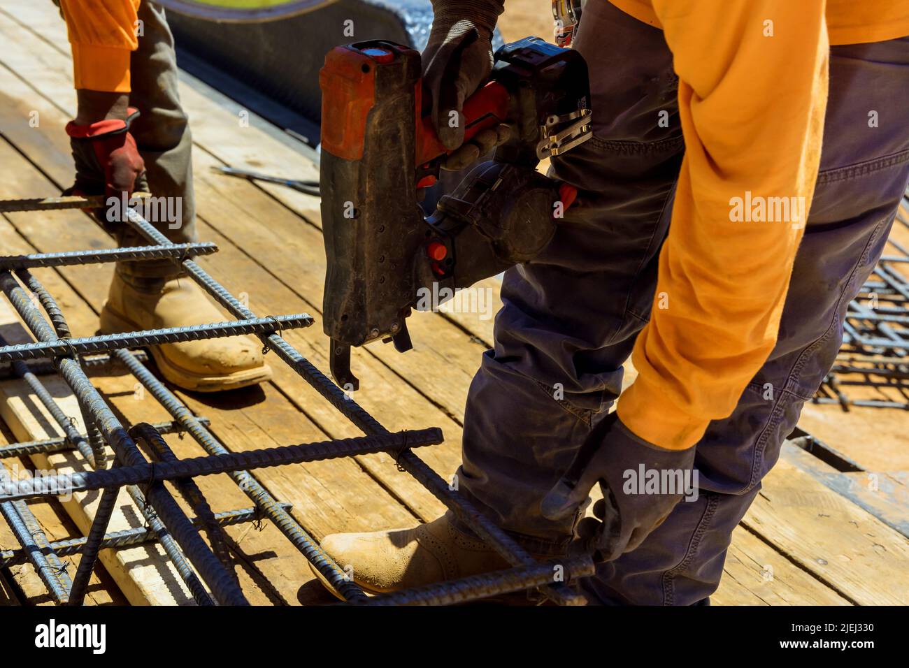 Tool used by construction workers to tie steel bars with wire rods for ...