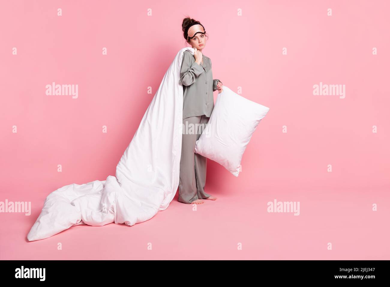 Full size photo of unsatisfied young girl standing hold cushion blanket ...