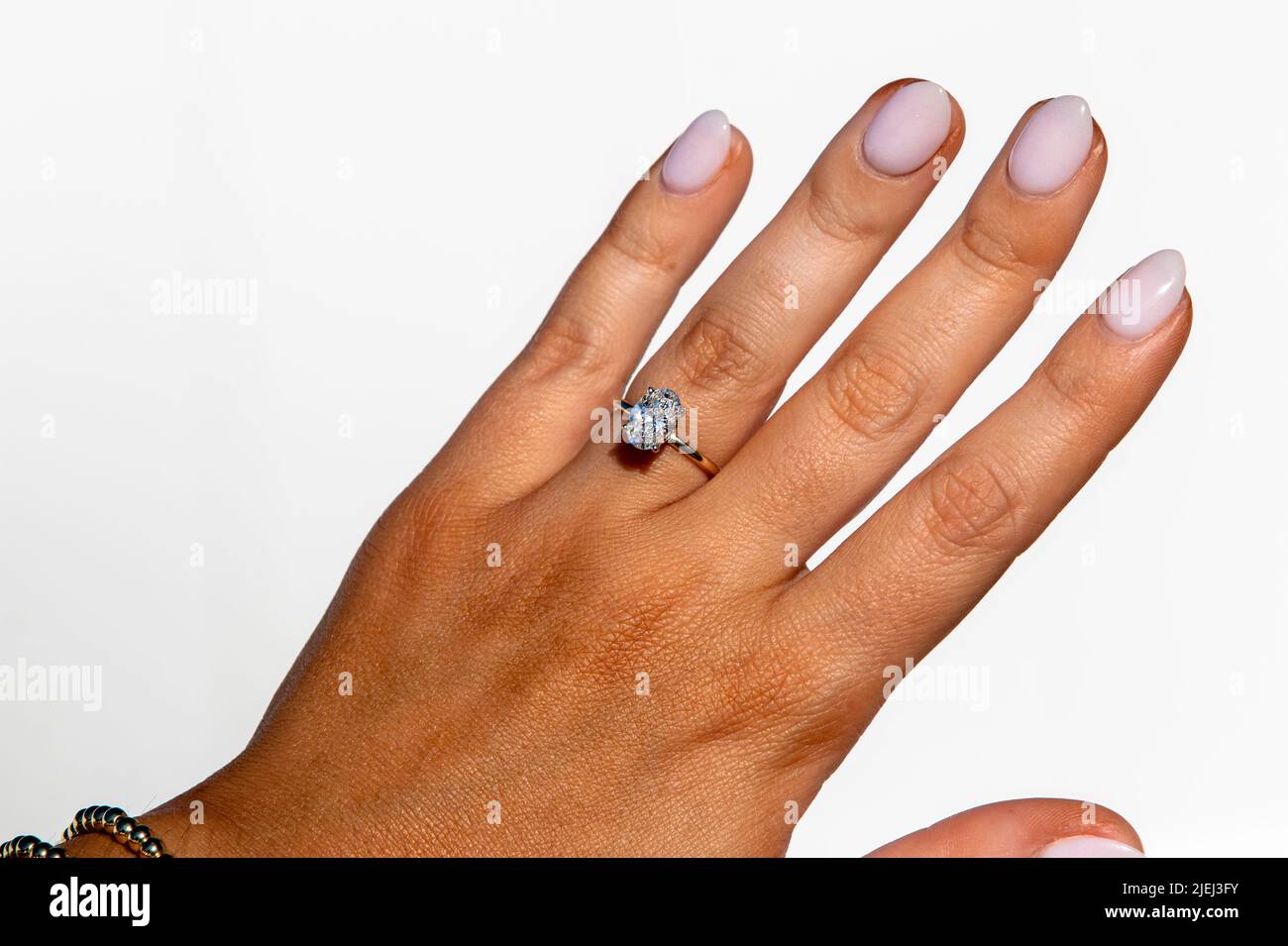 A young women shows off her new emgagement ring on her finger moments ...