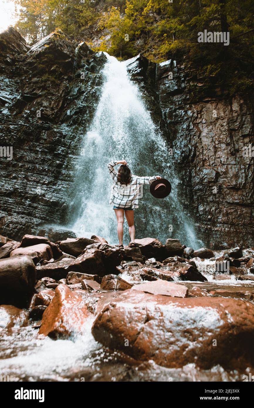 woman traveler enjoying view of waterfall copy space Stock Photo - Alamy