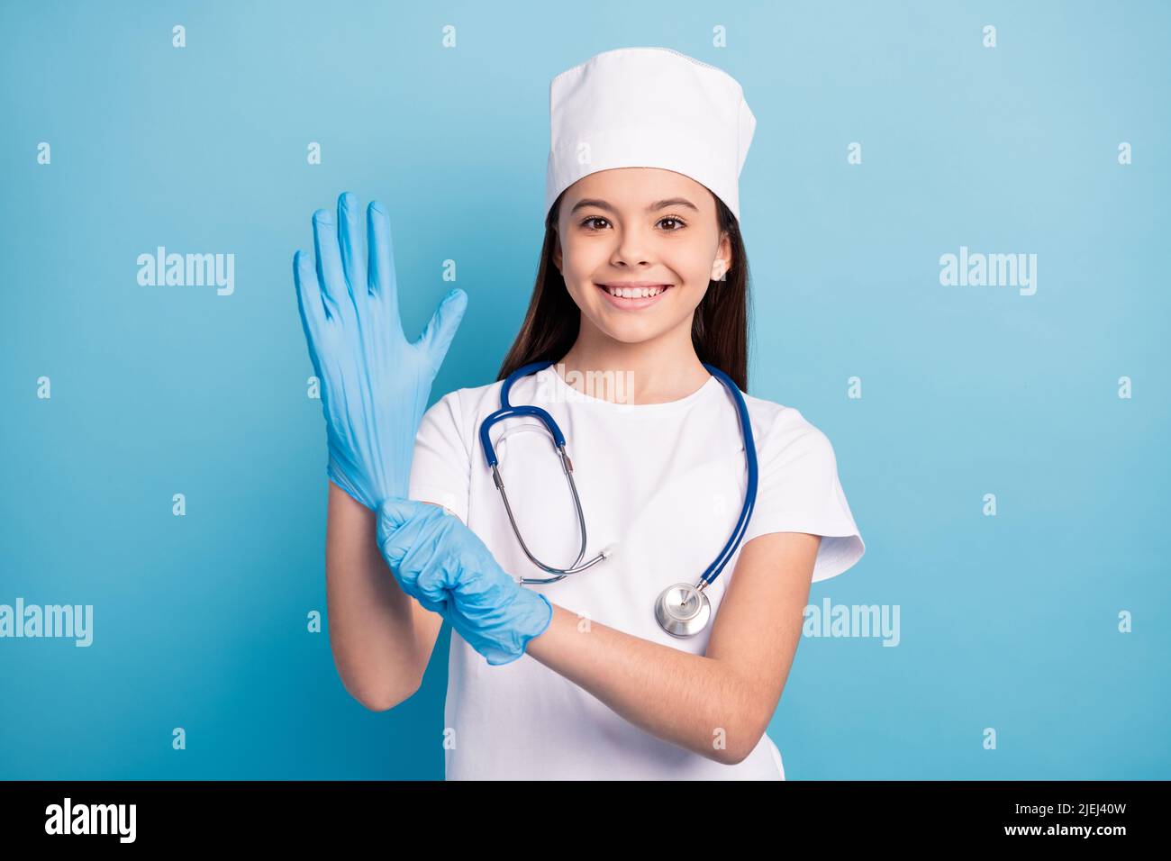 Photo portrait of small nurse with stethoscope put on medical gloves preparing isolated vibrant ...