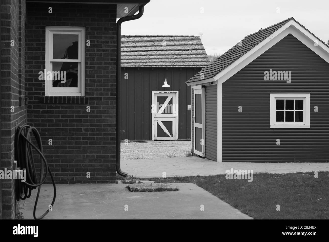 Traditional farmyard with a farmhouse, tool shed, and a storage shed in ...