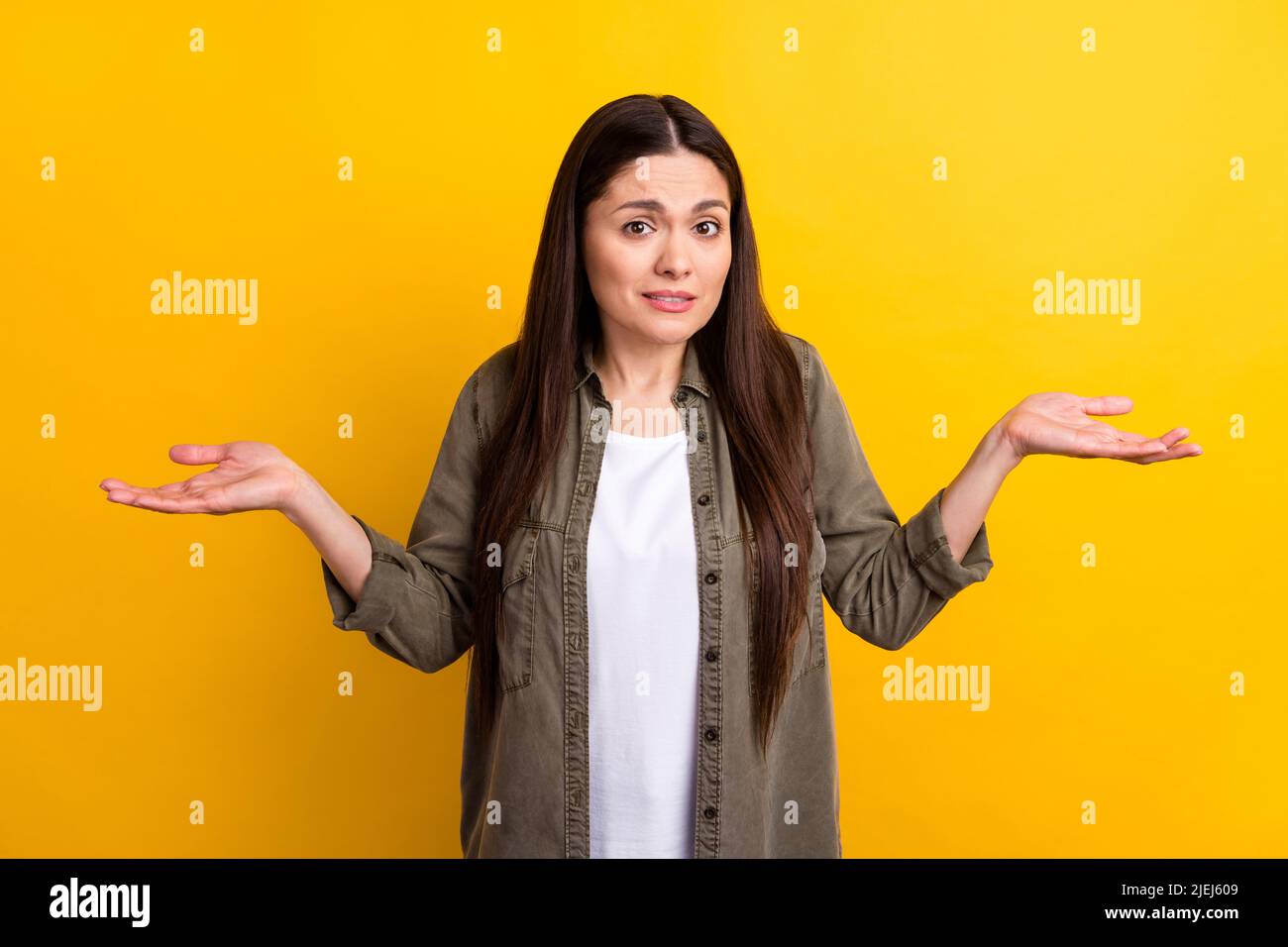 Photo of clueless young woman shrug shoulders raise hands no idea ...