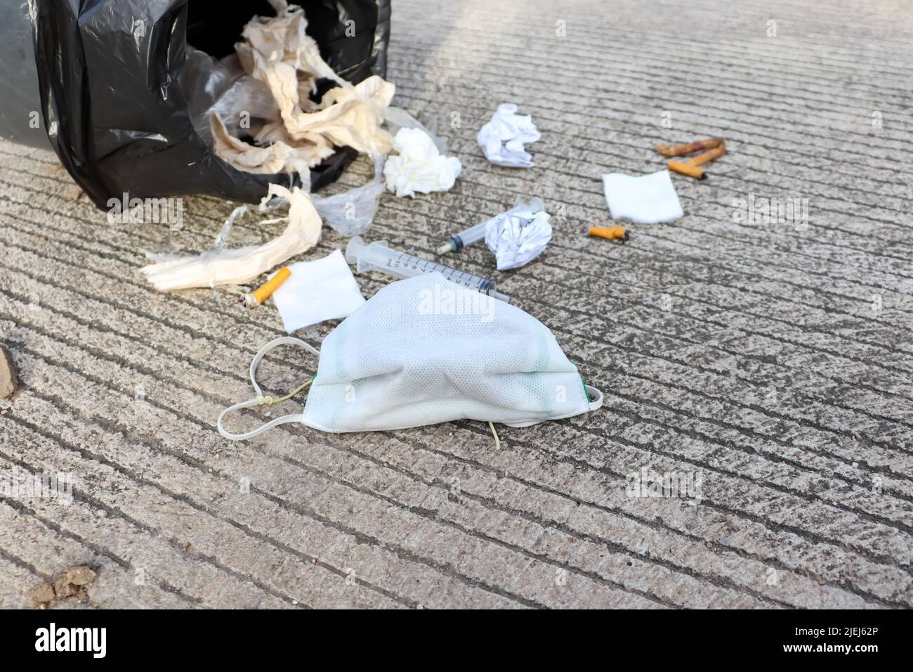 Full garbage spread on the side of the road Stock Photo - Alamy