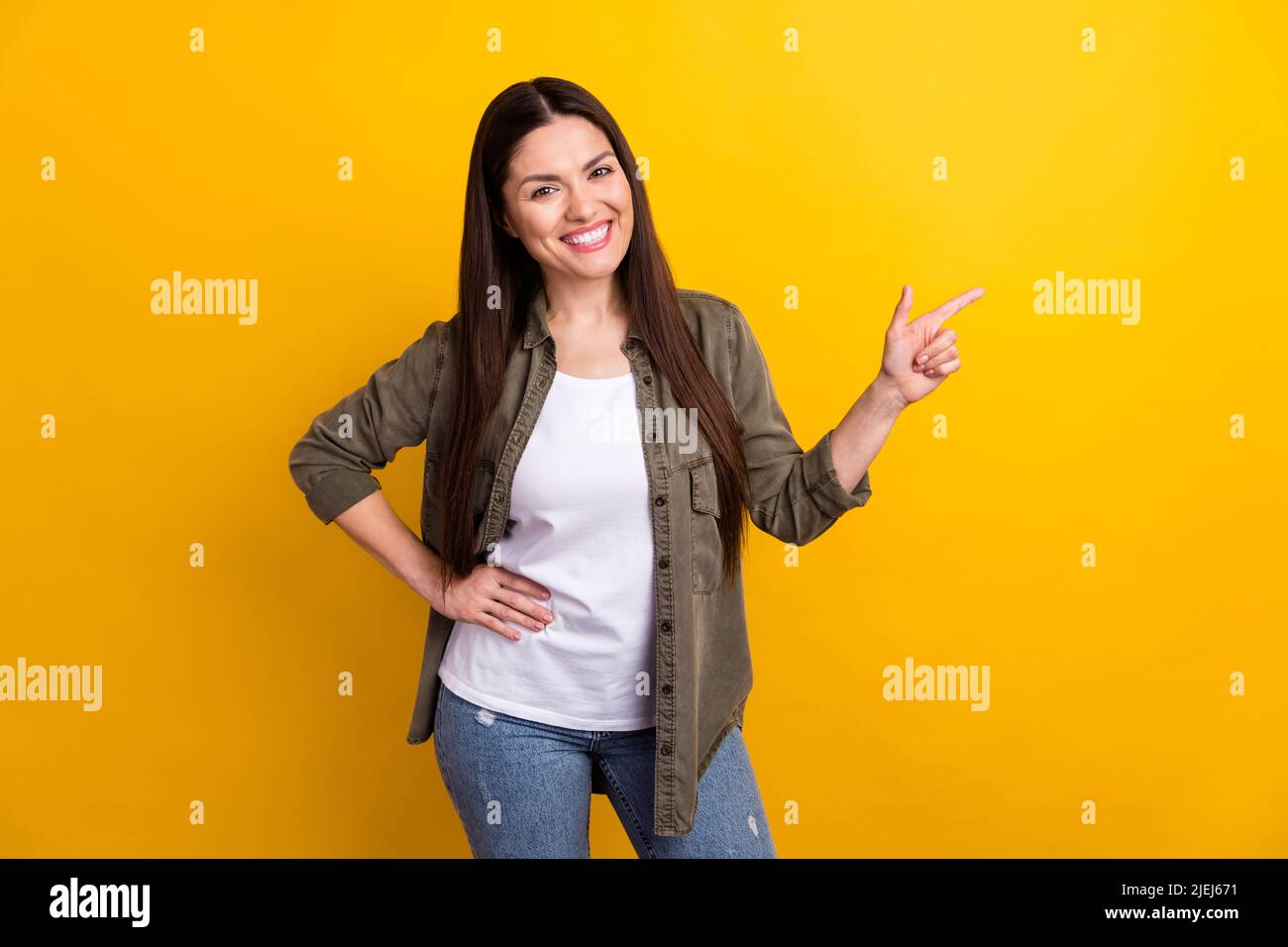 Photo of impressed charming young woman wear khaki outfit pointing ...