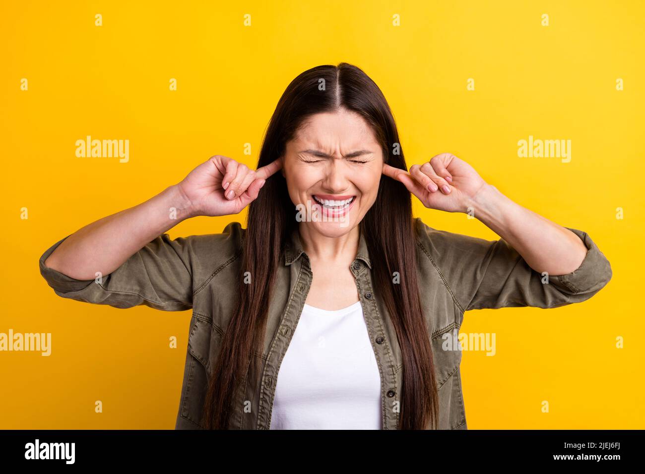 Photo of unhappy upset young woman close eyes ears fingers avoid noise ...