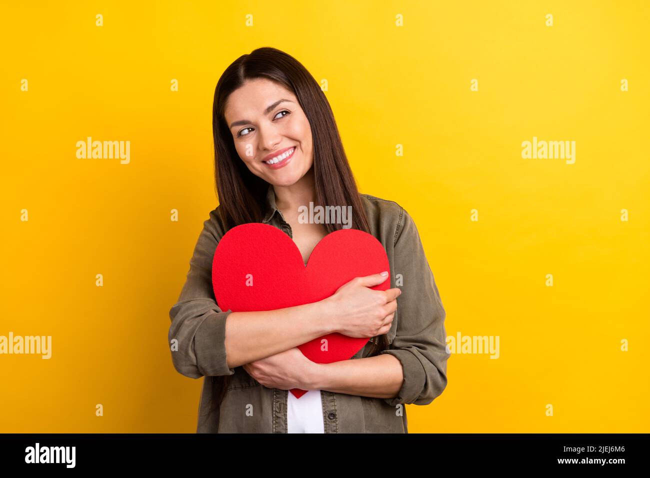 Photo of charming dreamy young happy woman look empty space embrace big ...