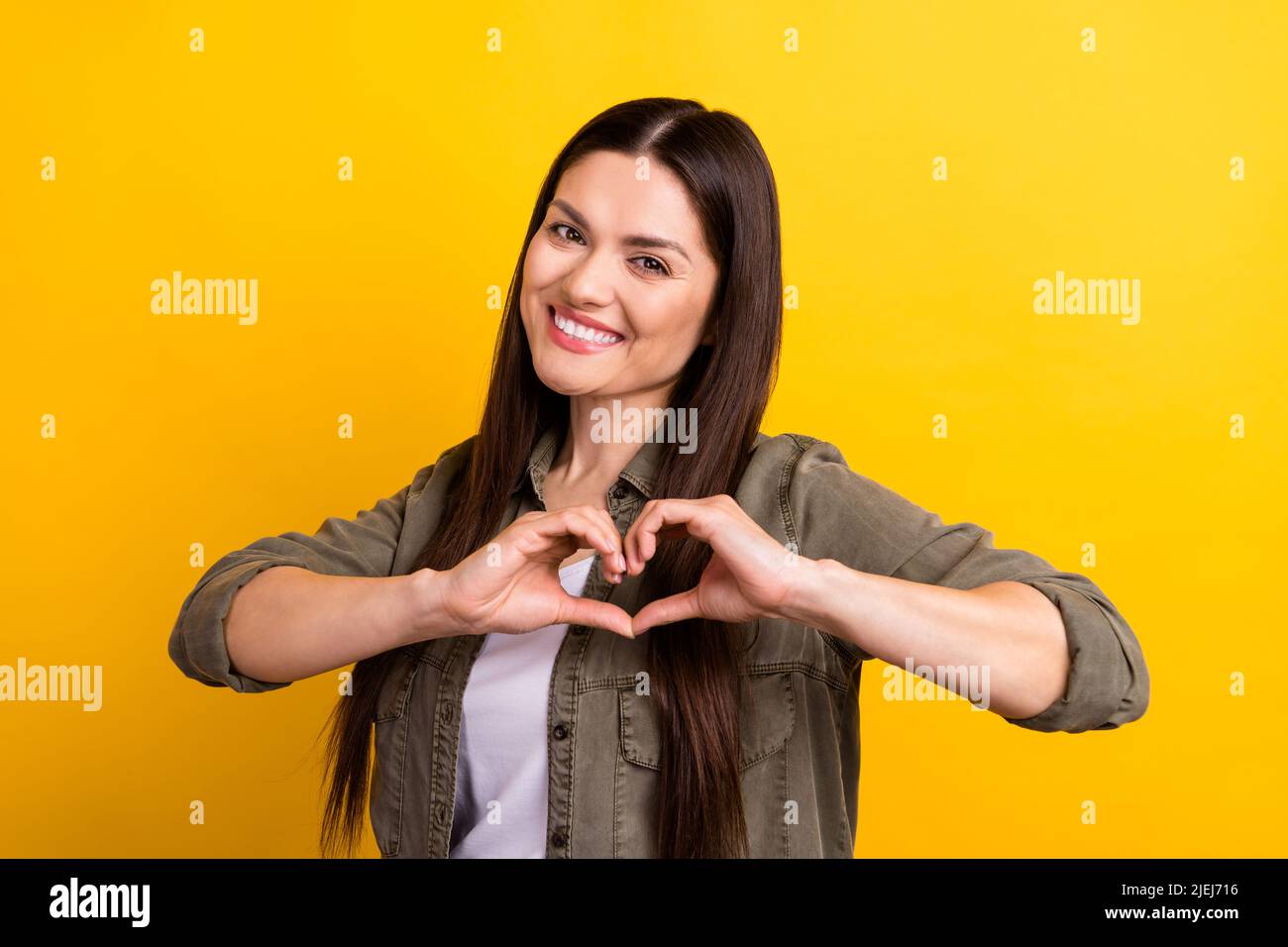 Photo of cheerful nice adorable young woman make fingers heart shape ...