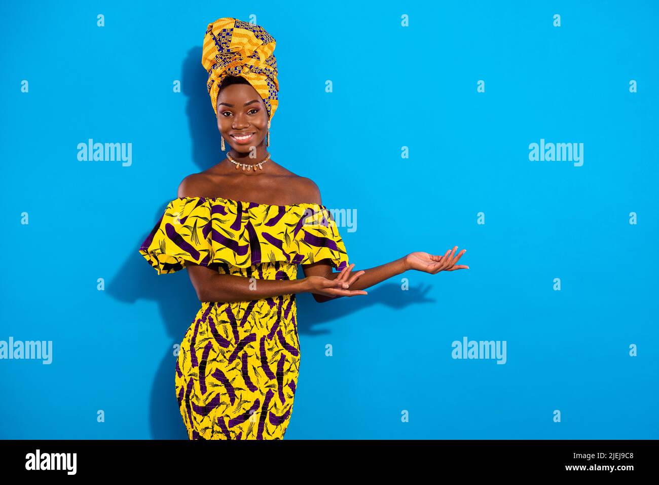 Photo of young sweet smiling african woman advertising product showing ...