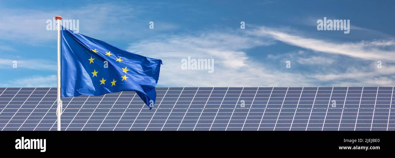 Official flag of the European Union in front of a large array of solar ...