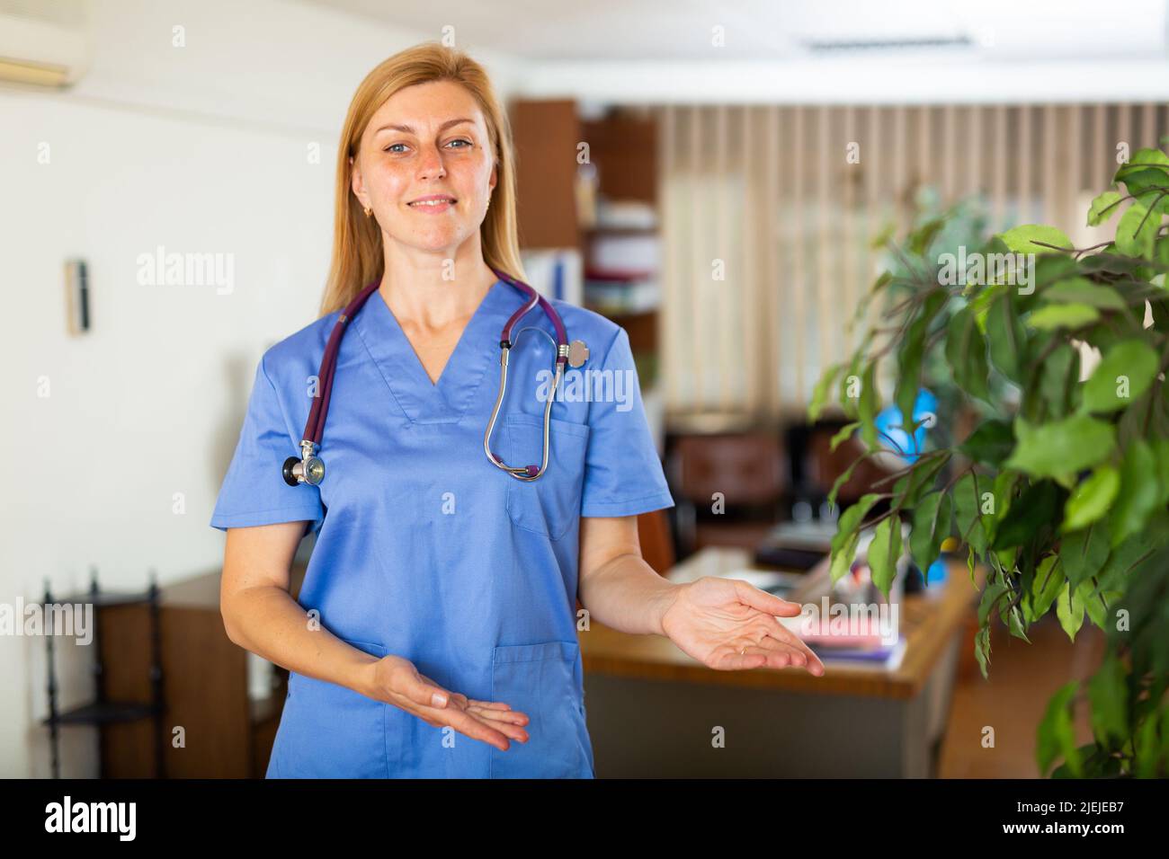 Female doctor assistant standing in medical office Stock Photo - Alamy