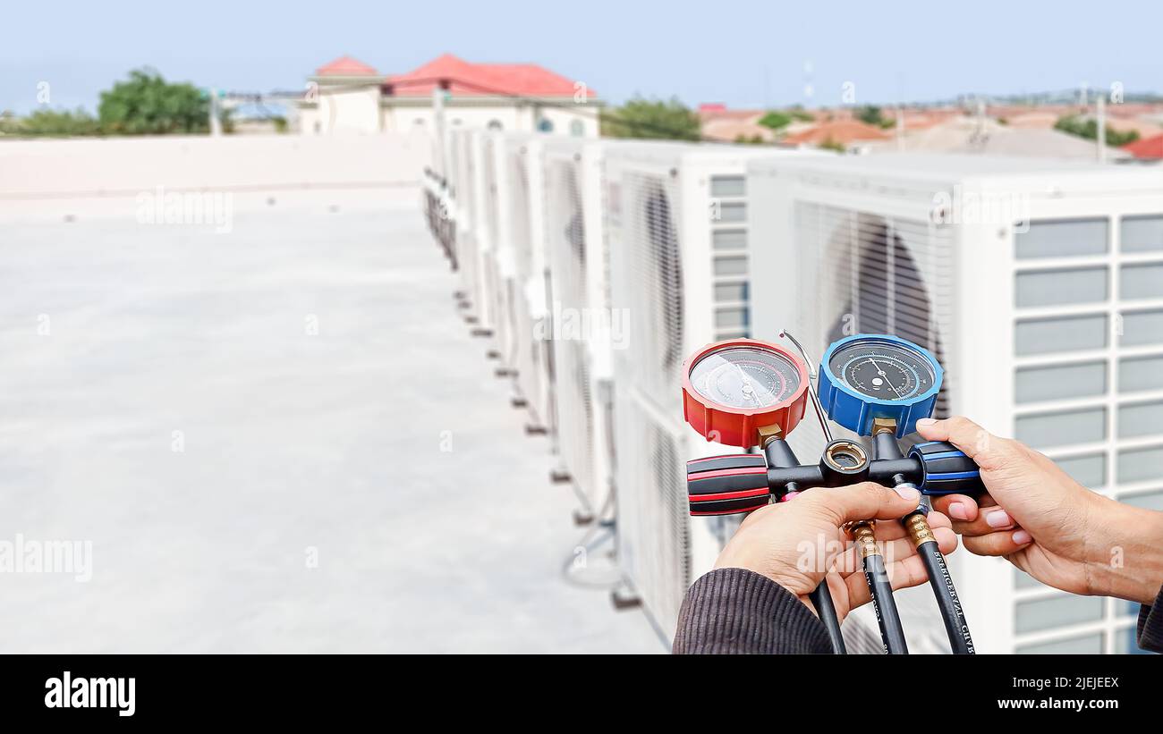 Air conditioner technician checking air conditioner operation Stock ...