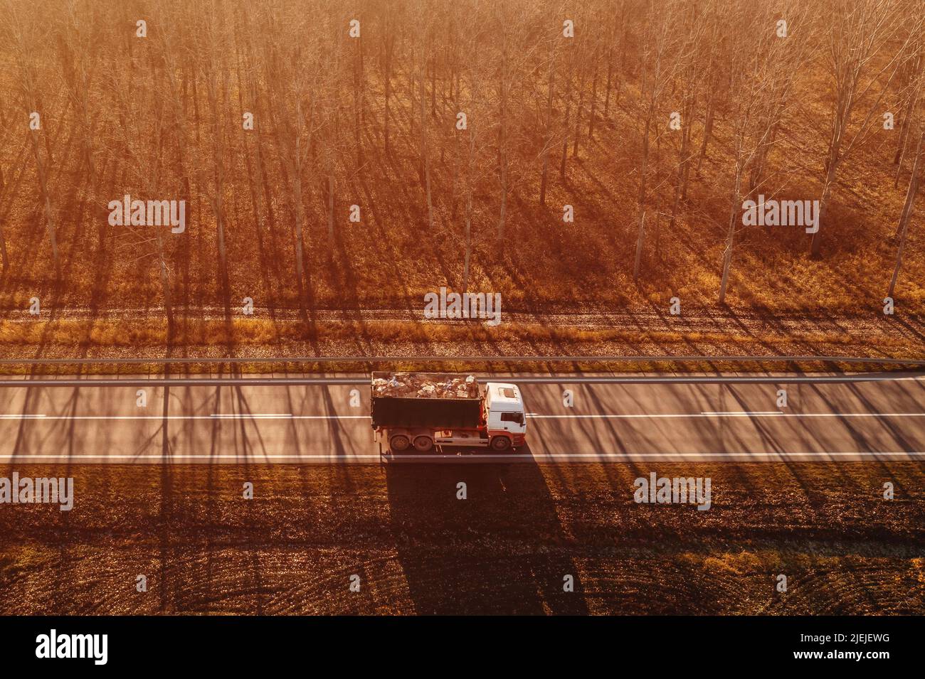 Aerial view of truck with waste paper loaded in wagon driving through ...